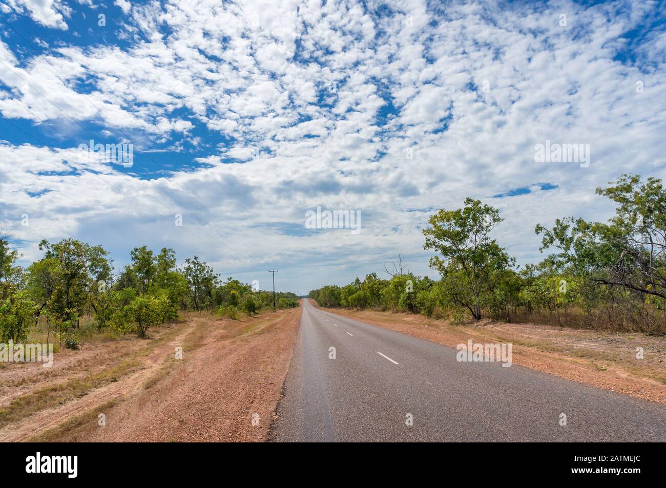 Long straight two lane road in Australian outback with trees on ...