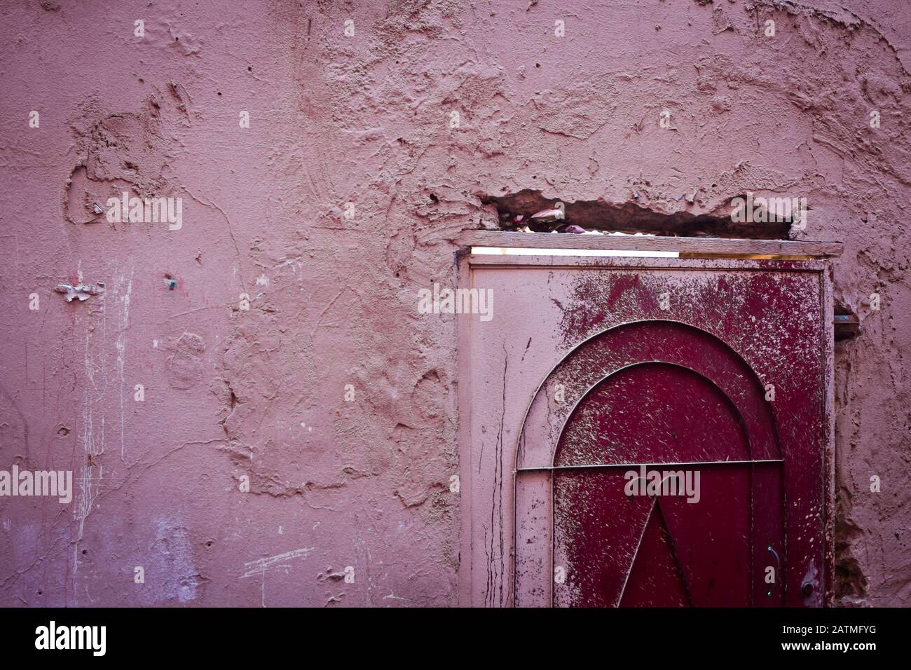 Paint from a wall overflows onto a door in Marrakesh, Morocco Stock ...
