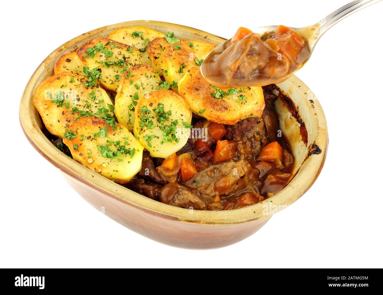Traditional potato topped Lancashire hotpot isolated on a white ...