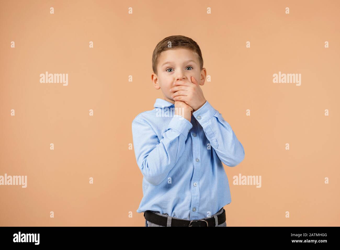 little boy asking to be quiet. child closes her mouth with his hand. I ...