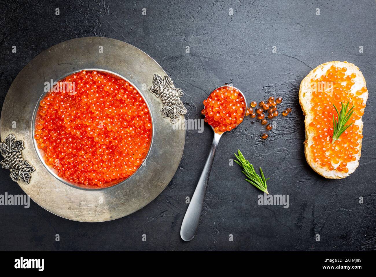 Delicious red caviar in vintage plate, top view, dark background Stock ...