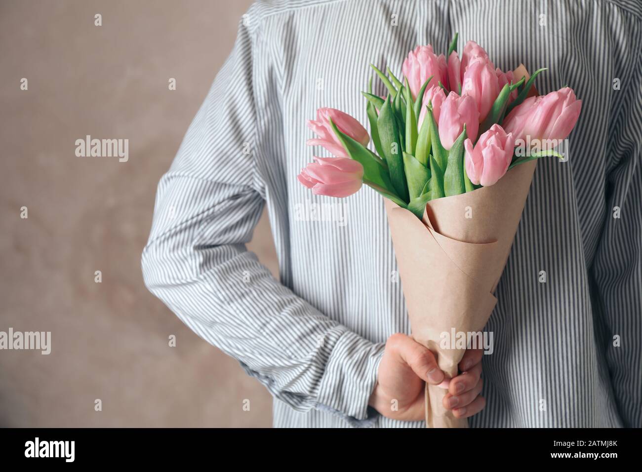 Husband hiding flower behind back hi-res stock photography and images ...