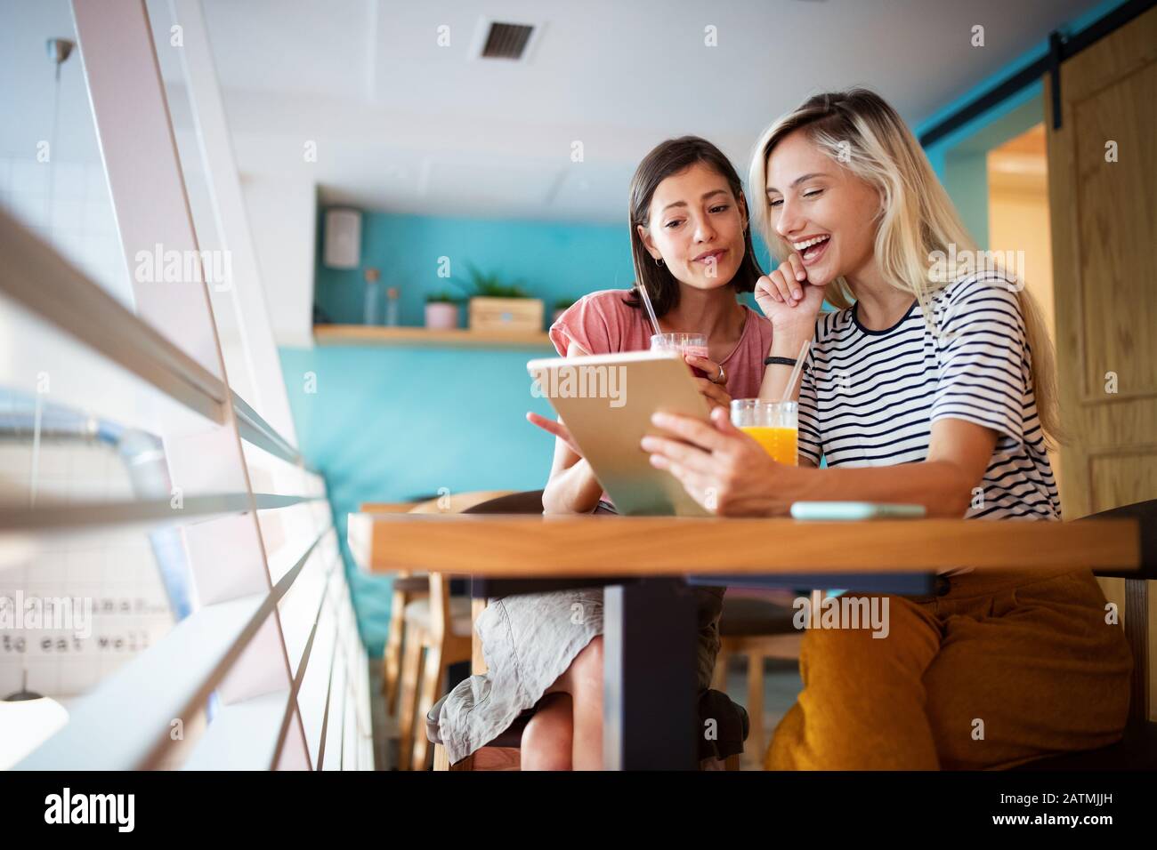 Happy young women friends having fun together, working, talking Stock ...