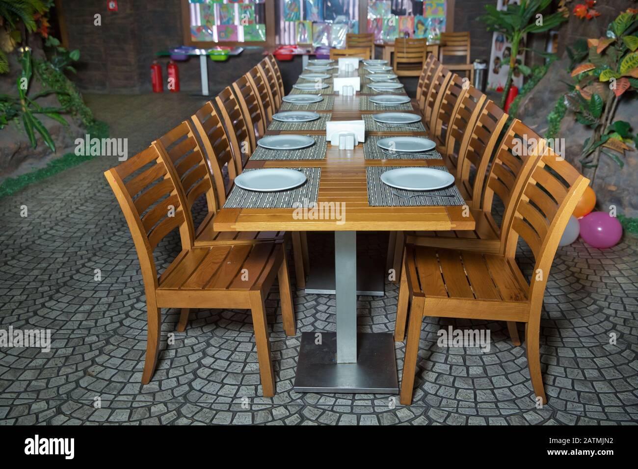 modern restaurant interior, table with cutlery, plate, glass, napkins ...
