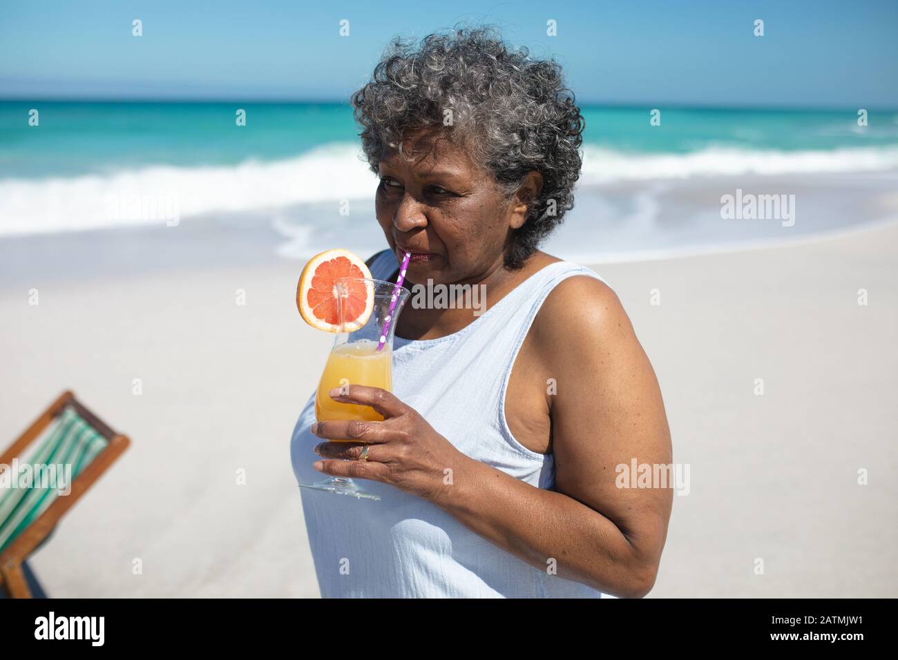 Old woman sunbathing beach hi-res stock photography and images - Alamy