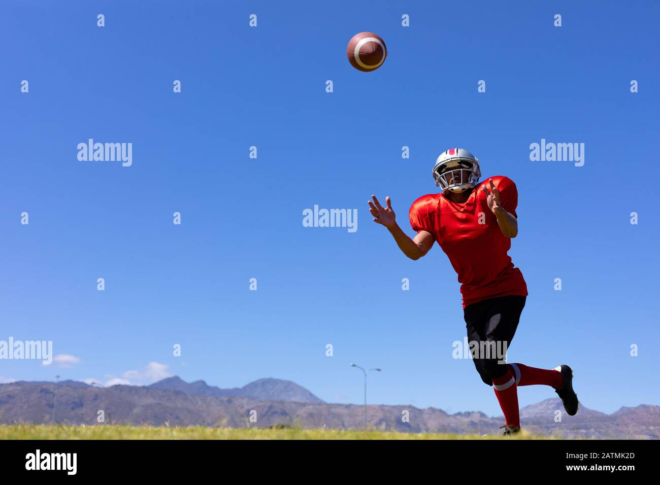 Football player playing football Stock Photo - Alamy