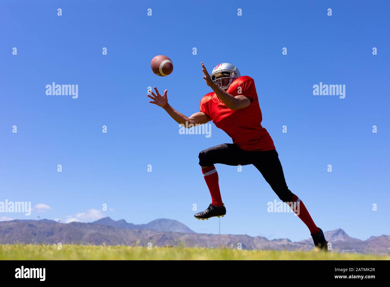 Football player playing football Stock Photo - Alamy
