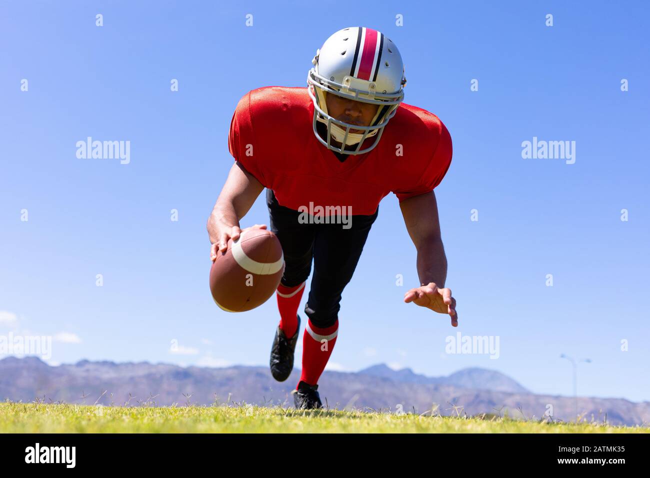 Football player playing football Stock Photo - Alamy