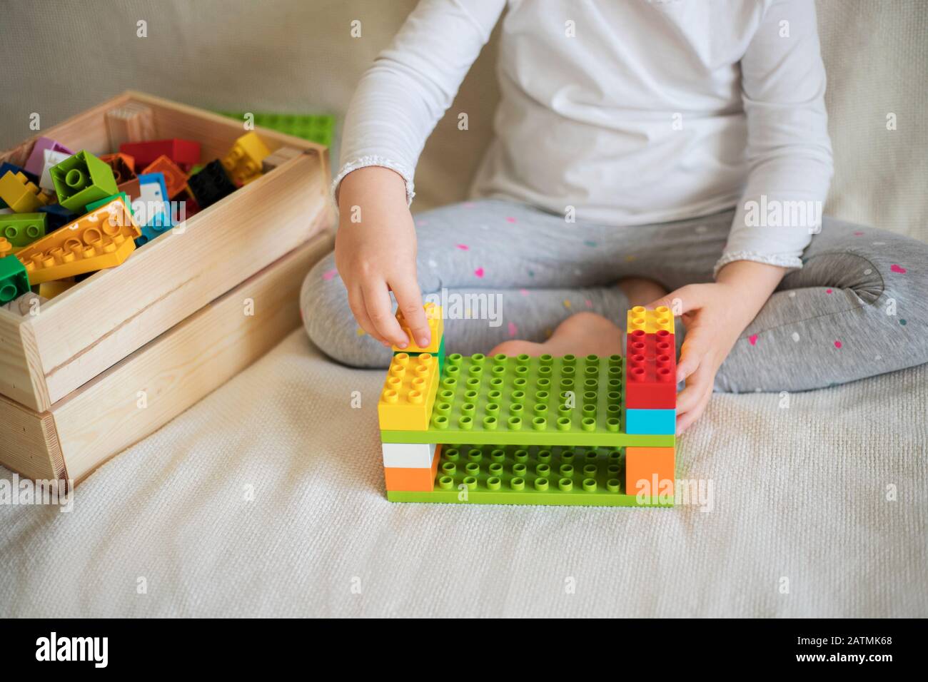 Little girl playing with her colorful blocks in her room Stock Photo ...