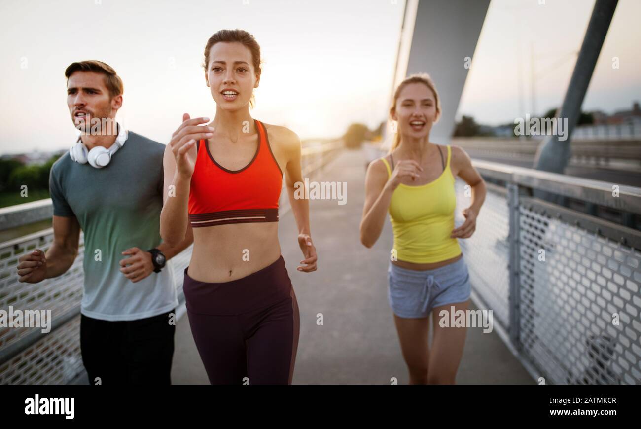 Fitness, sport, people and running concept. Happy fit friends running ...