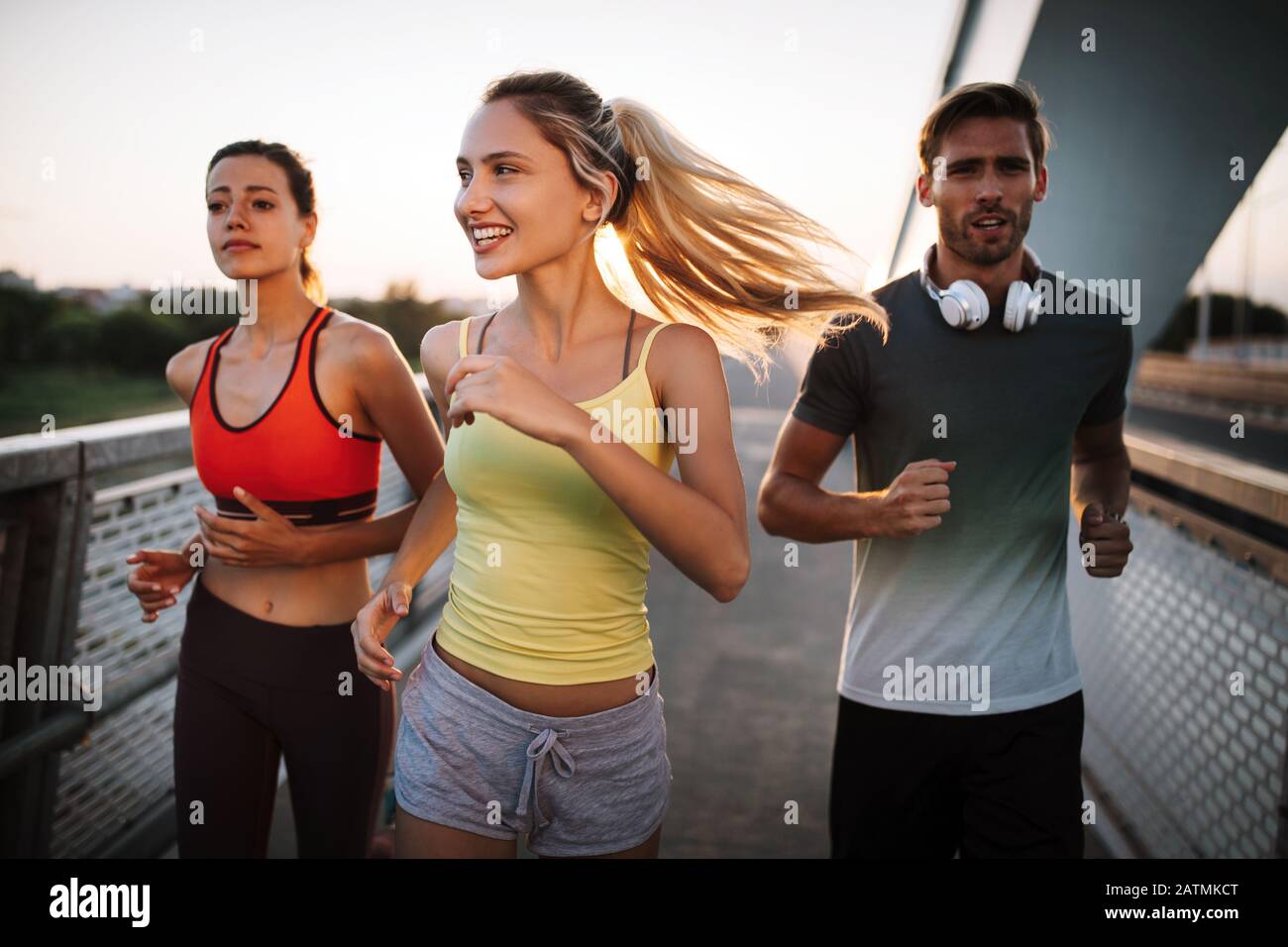 Fitness, sport, people and running concept. Happy fit friends running ...