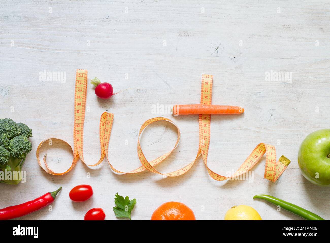 Diet word with tape measure fruits and vegetables on white background ...
