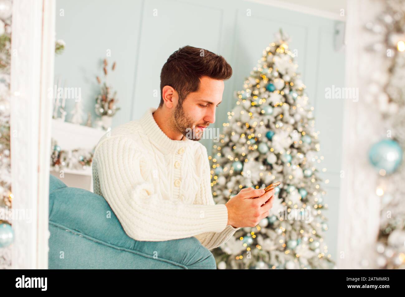 Side view man looking at his smartphone Stock Photo - Alamy