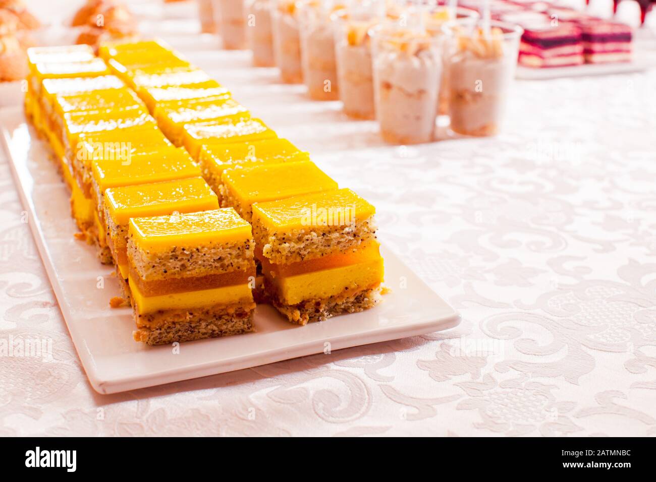 Lemon layer cake with poppy seeds at buffet Stock Photo - Alamy