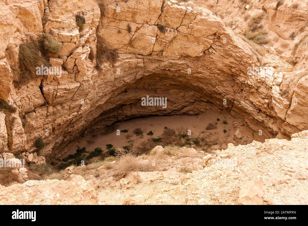 An eroded cave in the desert of Khafs Daghrah, Saudi Arabia Stock Photo ...