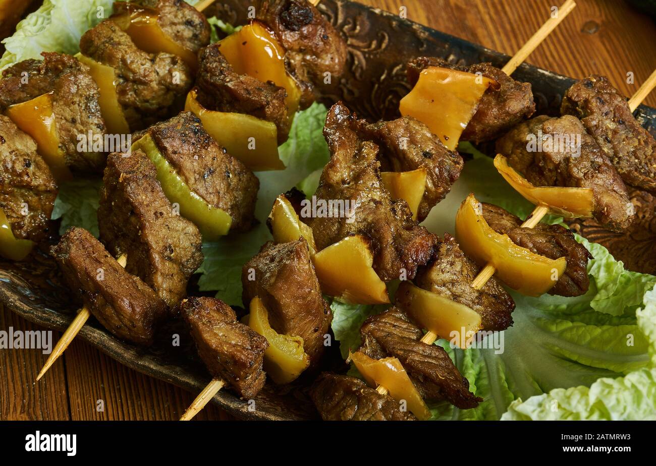 Mshikaki, street food dish , skewered pieces of marinated meat such as ...