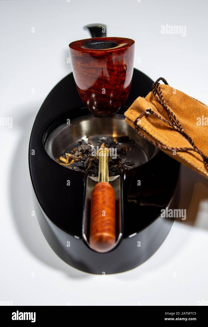 Pipe stopper on the ashtray with tobacco and pipe Stock Photo - Alamy
