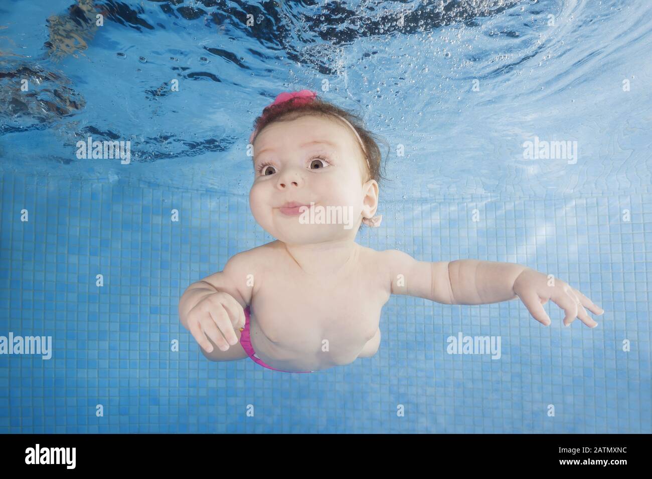 Little baby learning to swim underwater in a swimming pool hi-res stock ...