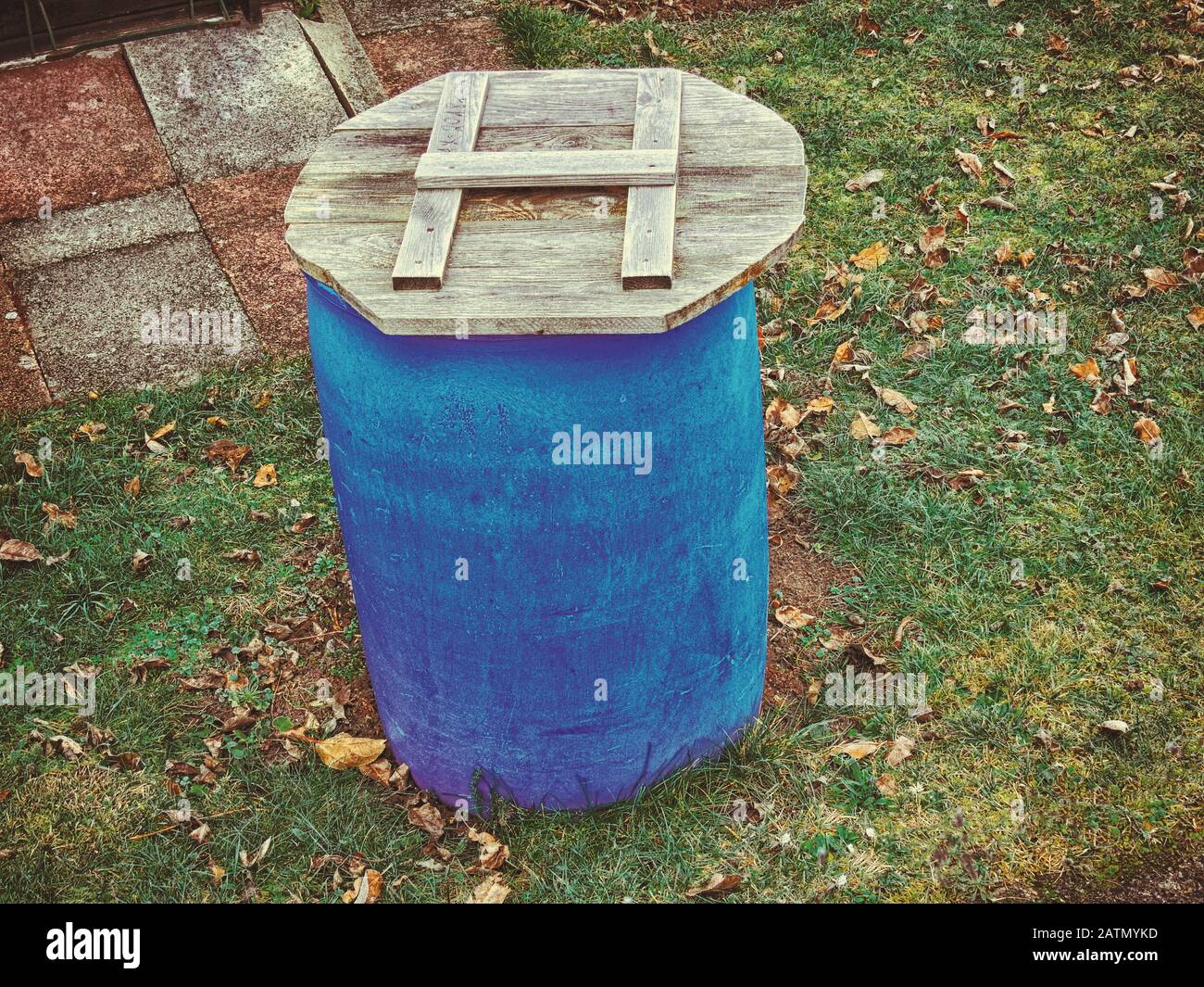 Blue covered barrel in the garden Stock Photo - Alamy