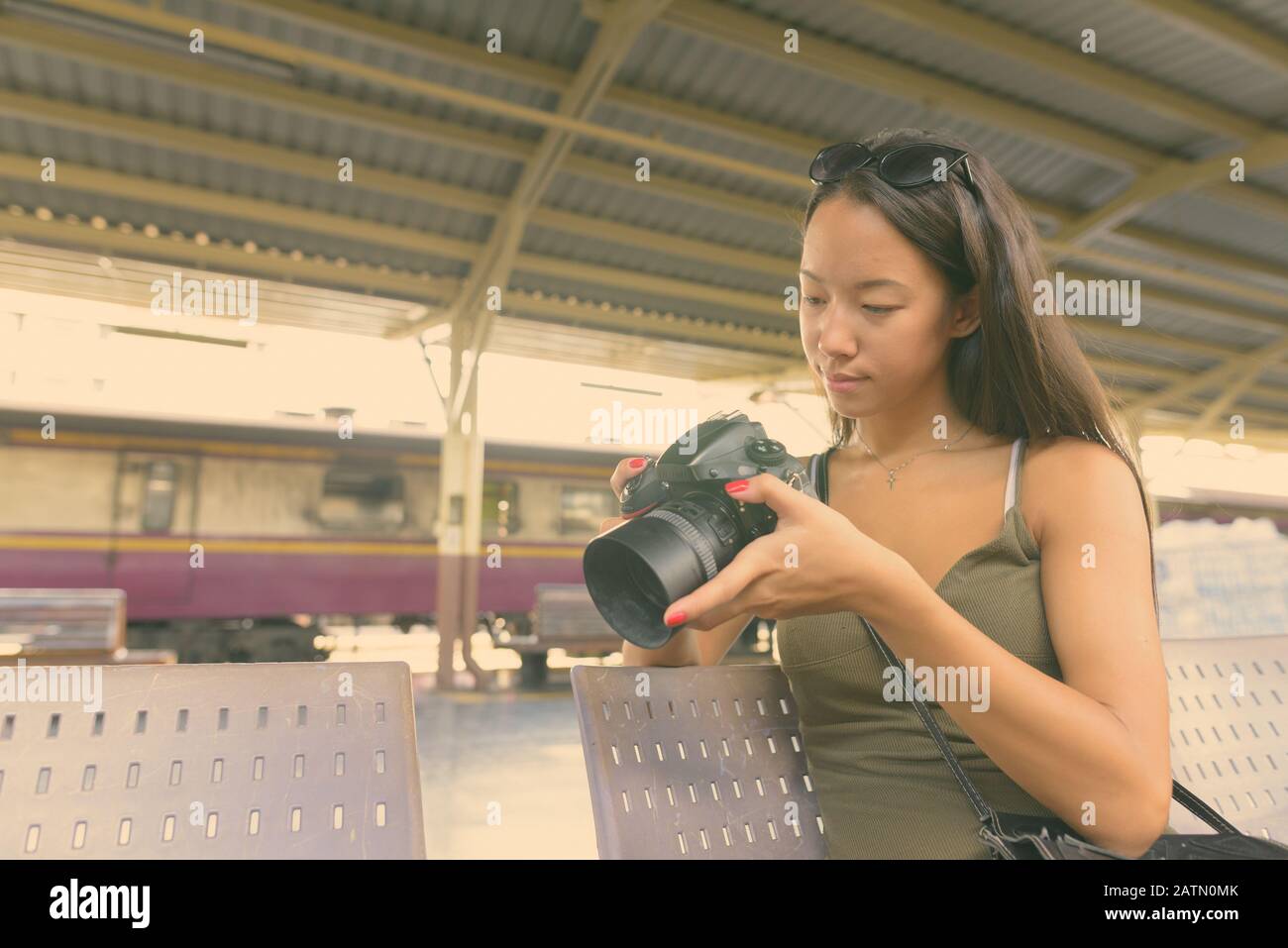 Young beautiful tourist woman with camera exploring the city Stock ... Young beautiful tourist woman with camera exploring the city Stock ...