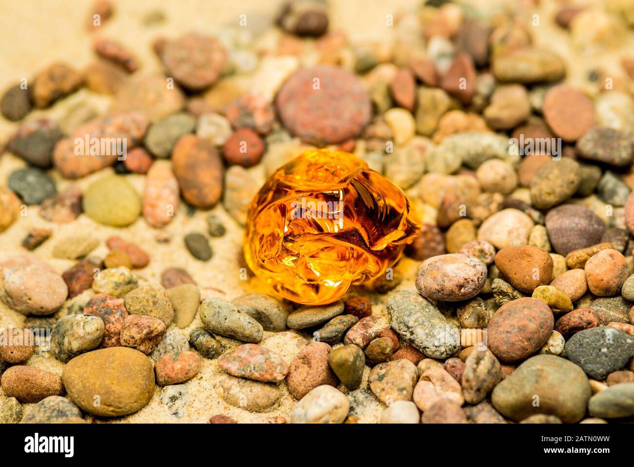 Amber on a beach with pebbles Stock Photo - Alamy