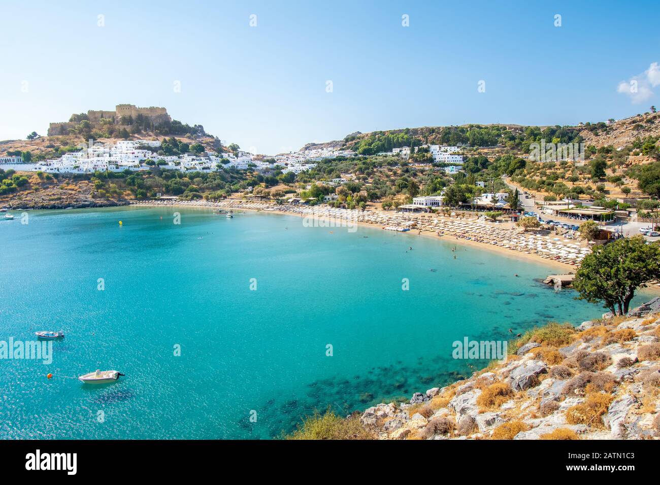 Lindos beach and white houses of village of Lindos and Acropolis in ...