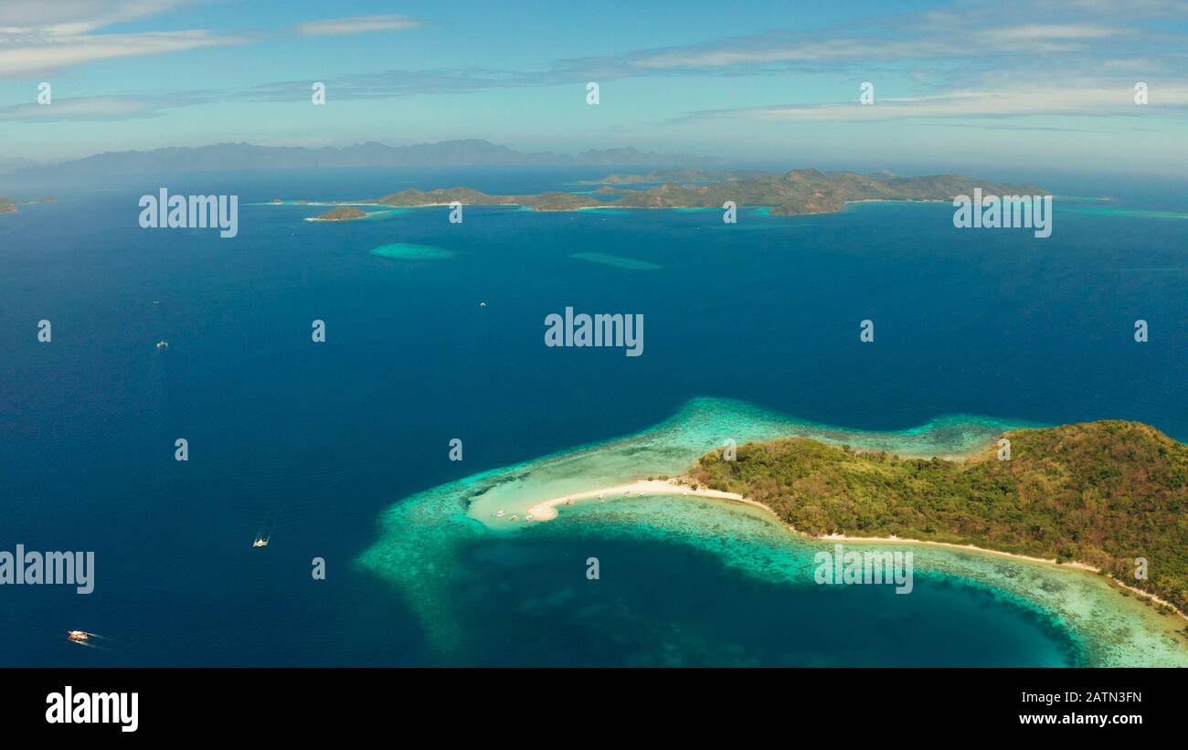 aerial seascape tropical island with sand bar, turquoise water and ...