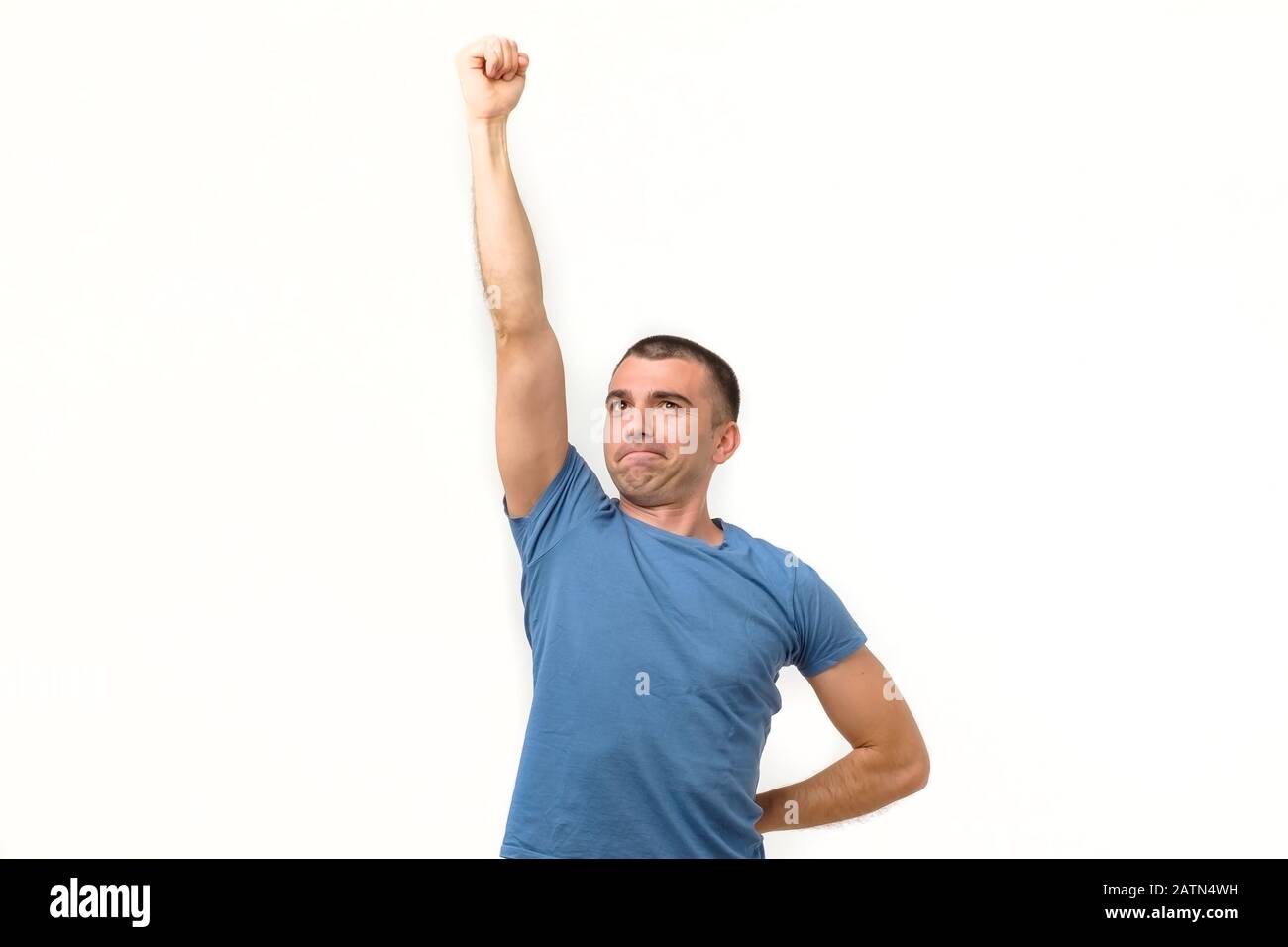 Young hispanic proud man jumped like a superman holding hand with fist ...