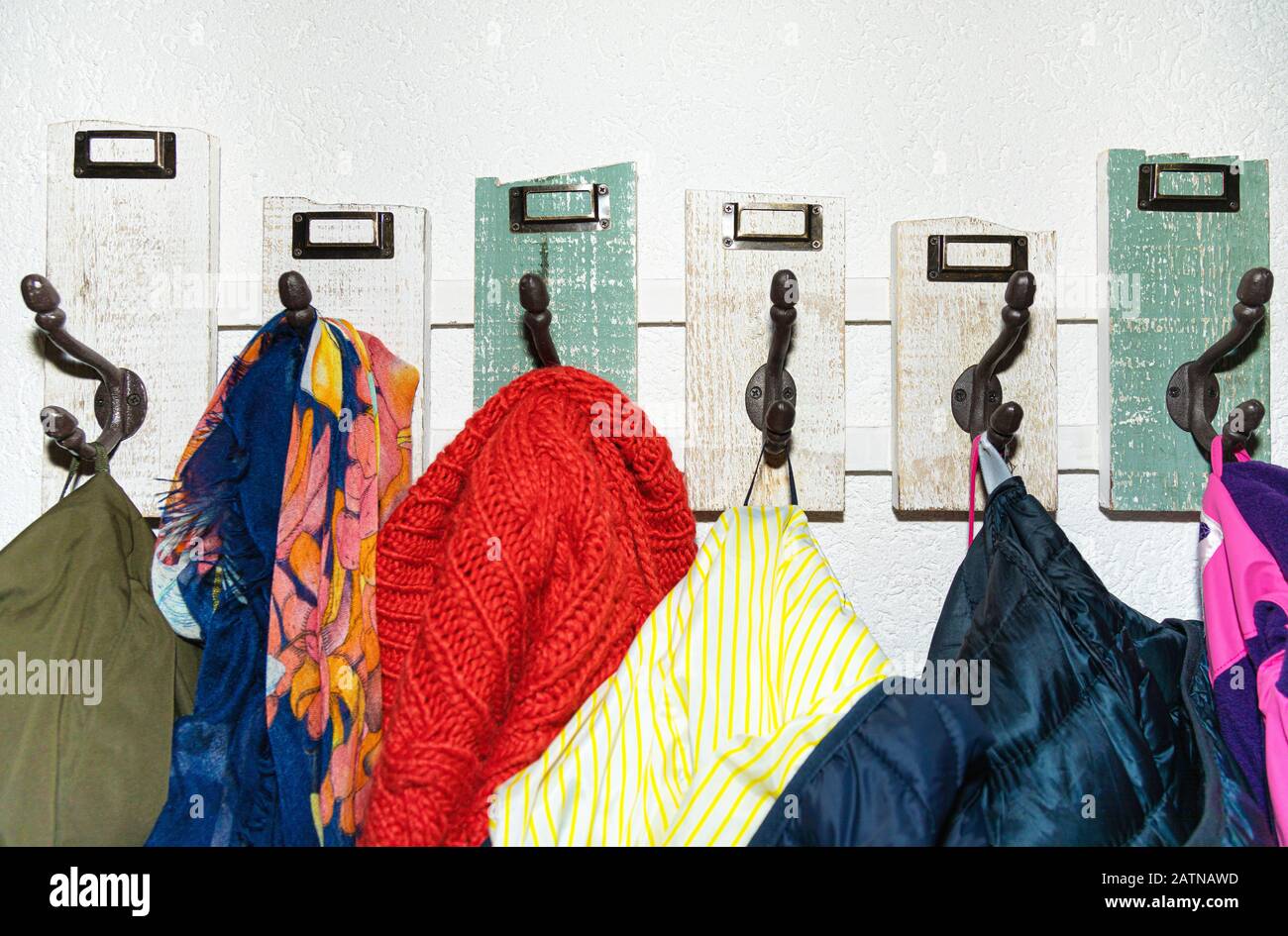 Colorful clothing, coats, jacket on wooden coat hook – cold winter ...