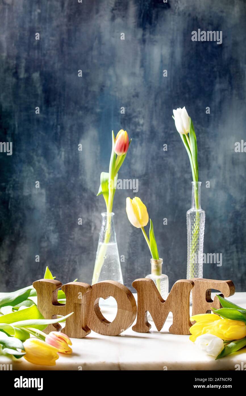 Wooden decorative letters word HOME with colorful tulips on white ...