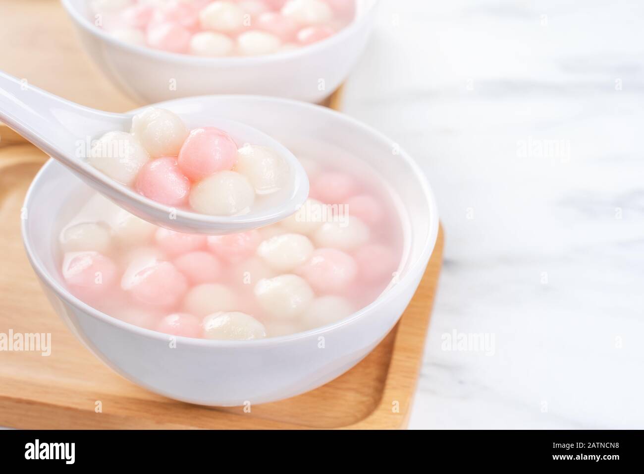 Delicious tang yuan, red and white rice dumpling balls in a small bowl ...