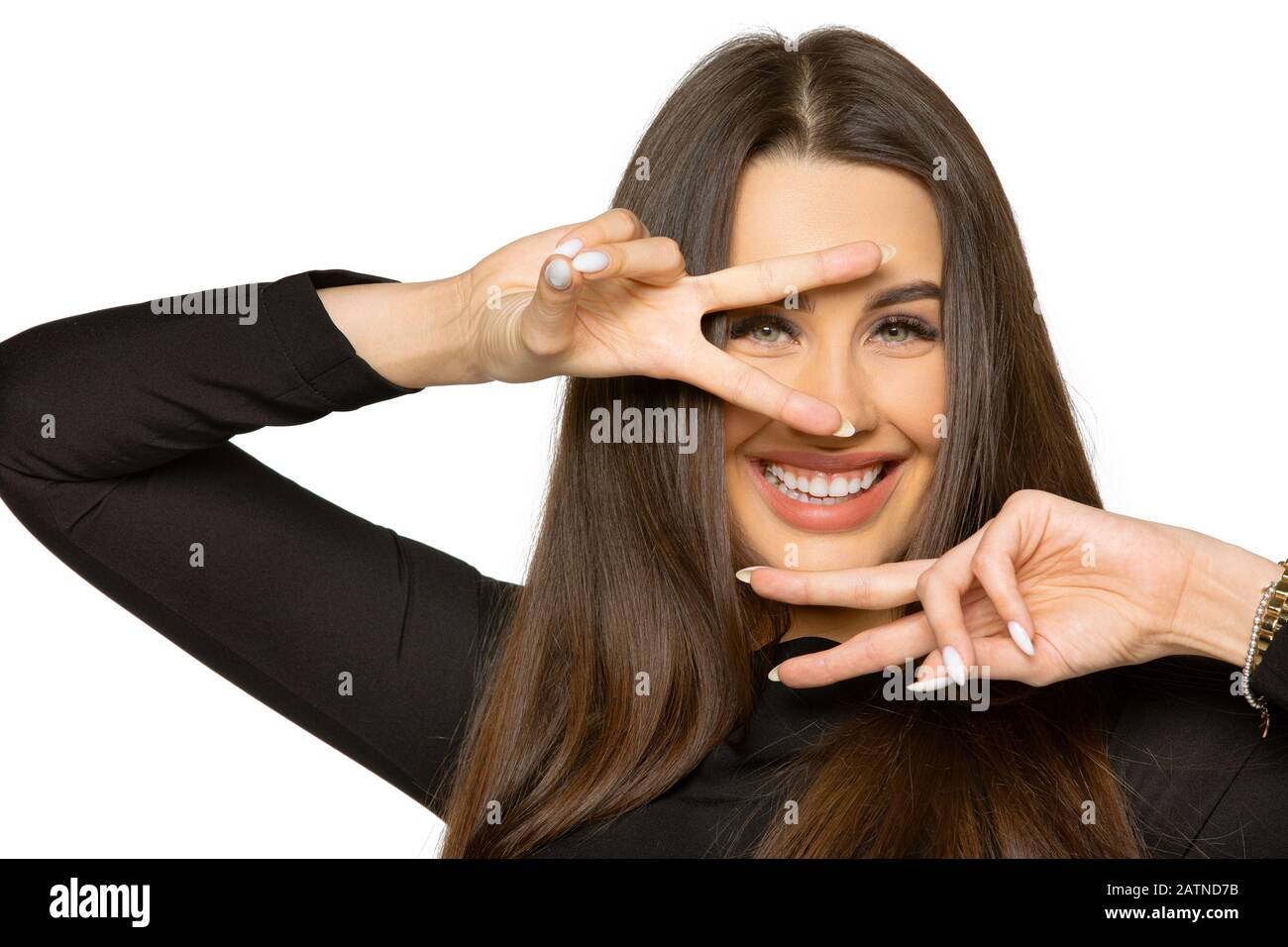 a young woman smiles and poses in the Studio. portrait of a model in ...