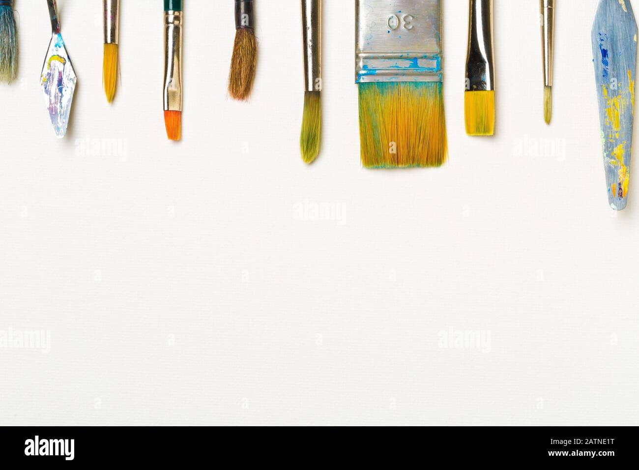 Artistic art supply utensils with paintbrushes on white background with ...