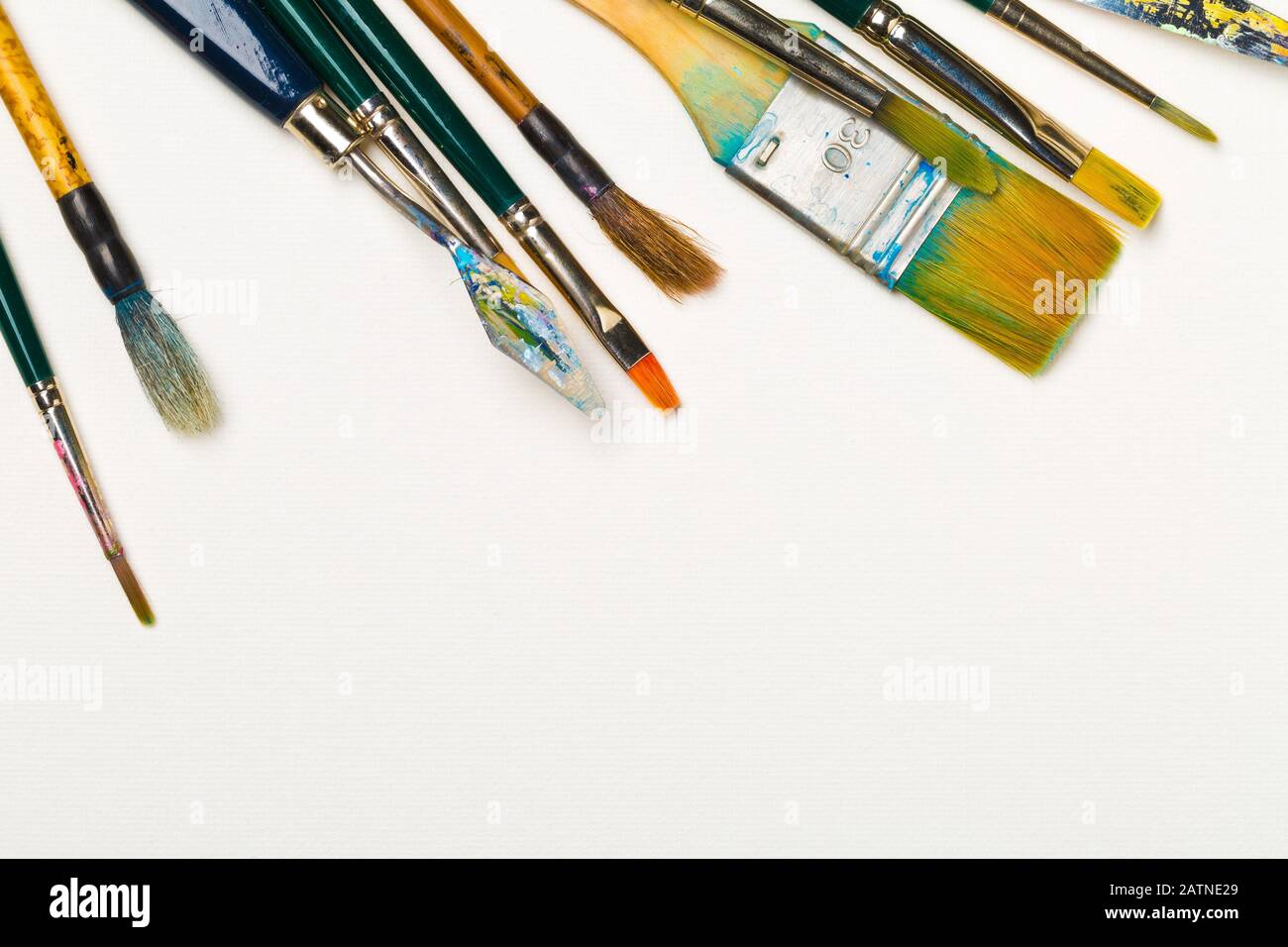 Artistic art supply utensils with paintbrushes on white background with ...