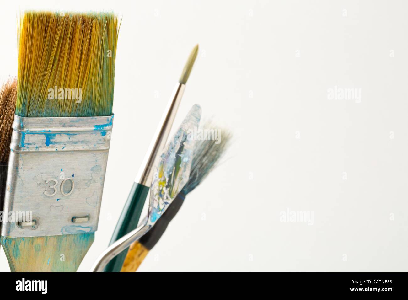 Artistic art supply utensils with paintbrushes isolated on white ...