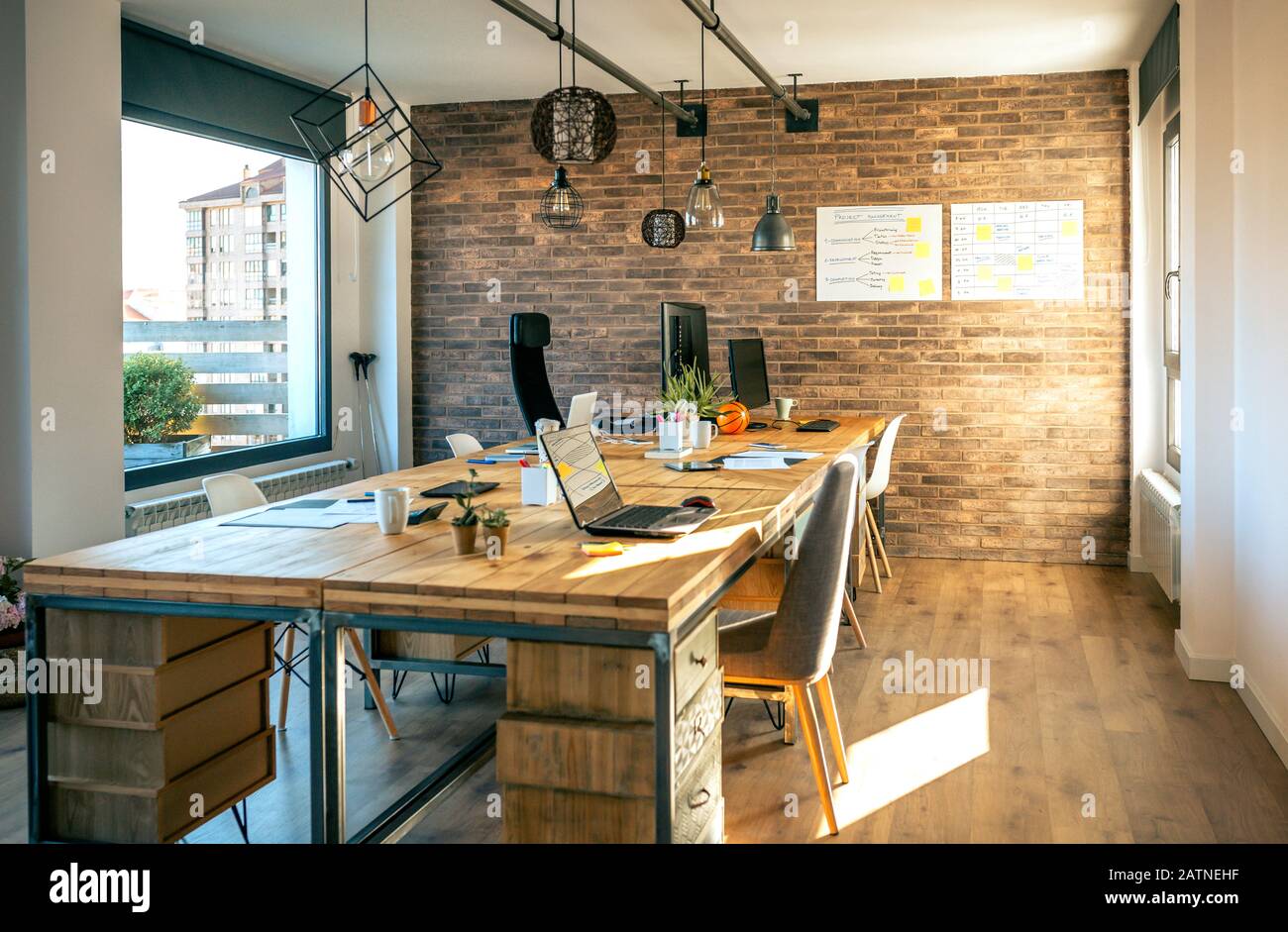 Interior of industrial style coworking office Stock Photo - Alamy