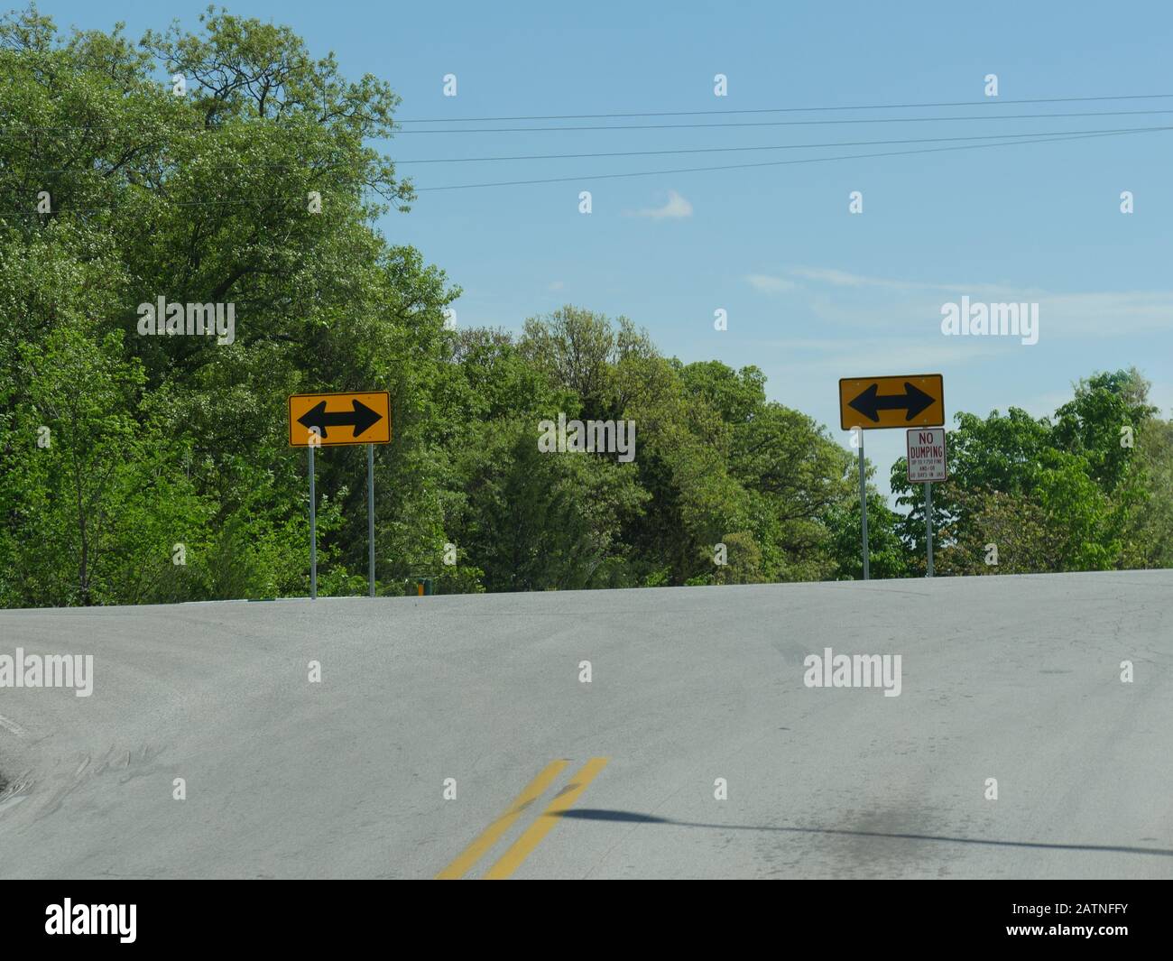 Road signs with arrows to opposite directions Stock Photo - Alamy
