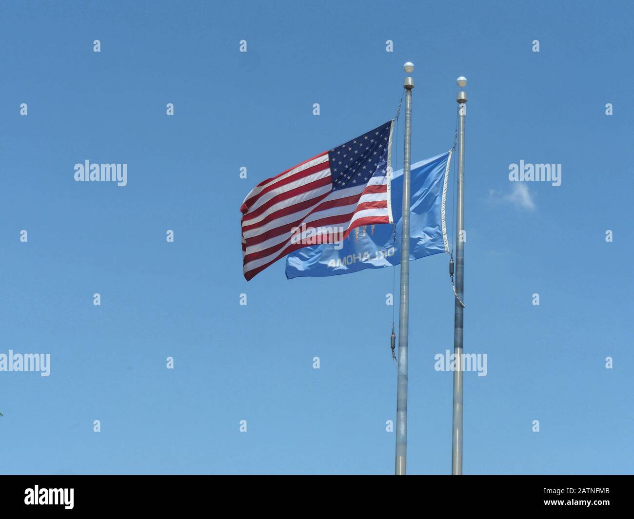 Flags of the United States of America and Oklahoma State from flagpoles ...