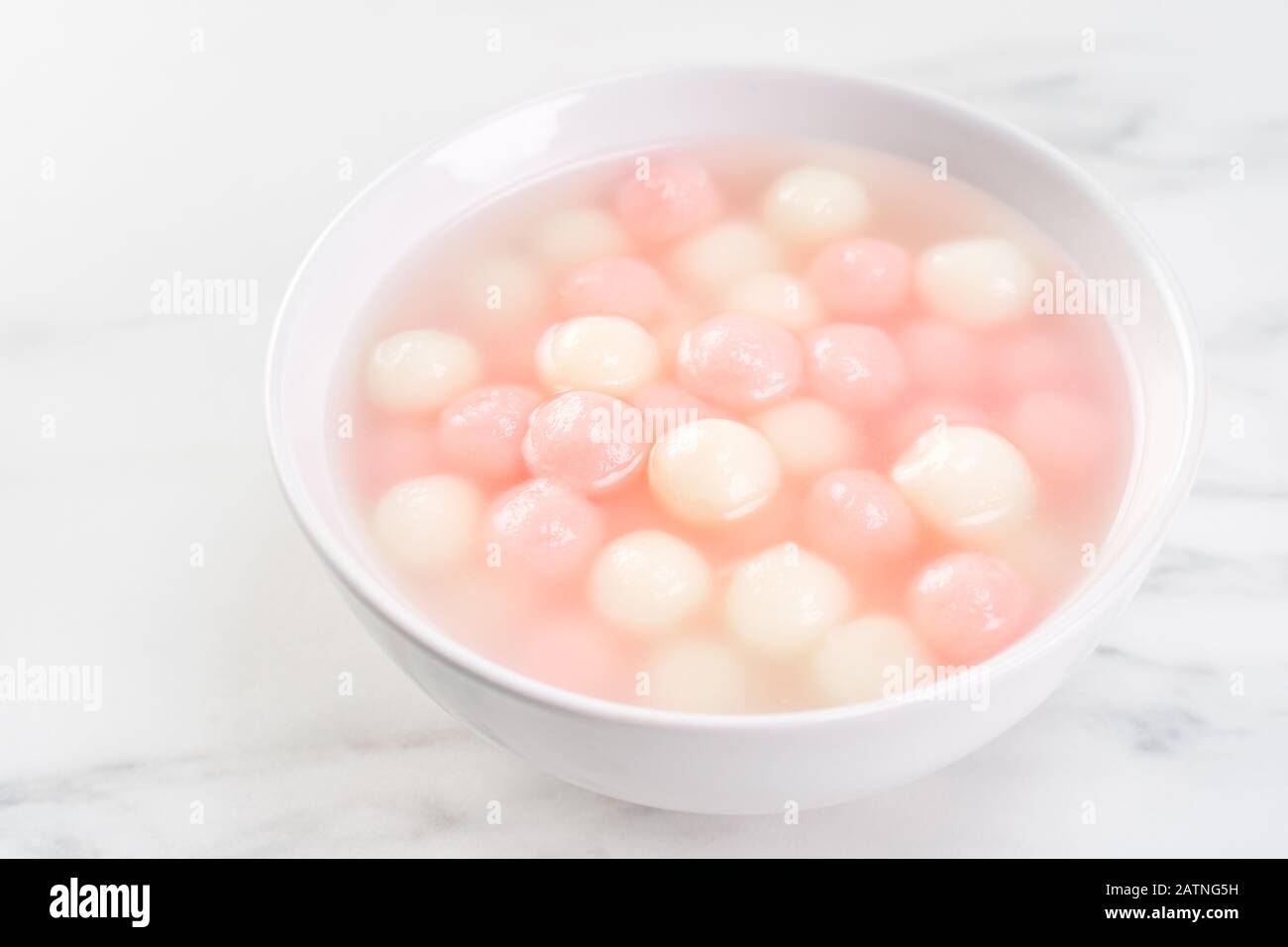 Delicious tang yuan, red and white rice dumpling balls in a small bowl ...