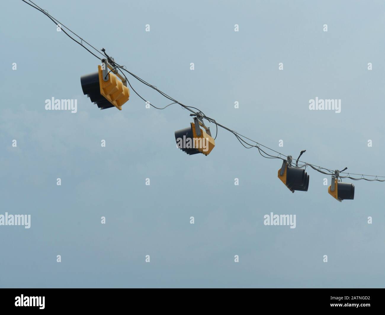 Old-fashioned traffic lights hanging by wires at an intersection Stock ...