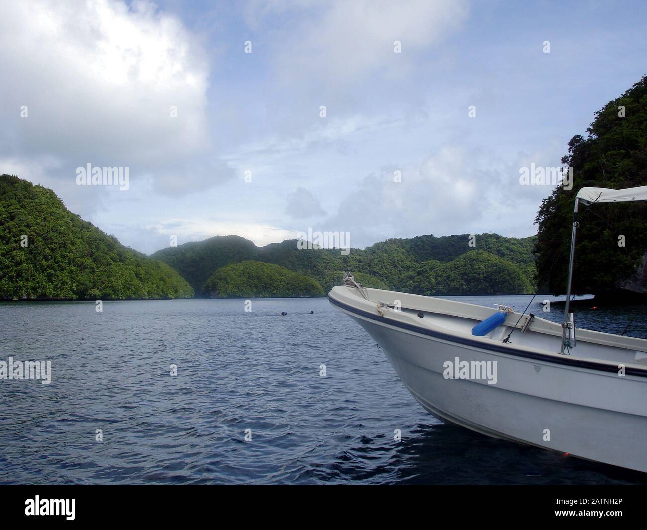 White boat in the blue waters with the Rock Islands in Palau Stock ...
