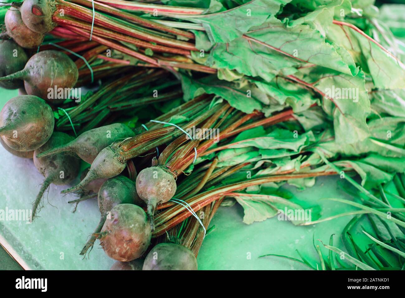 Bundles of young fresh beetroot lying on stall of street market ...
