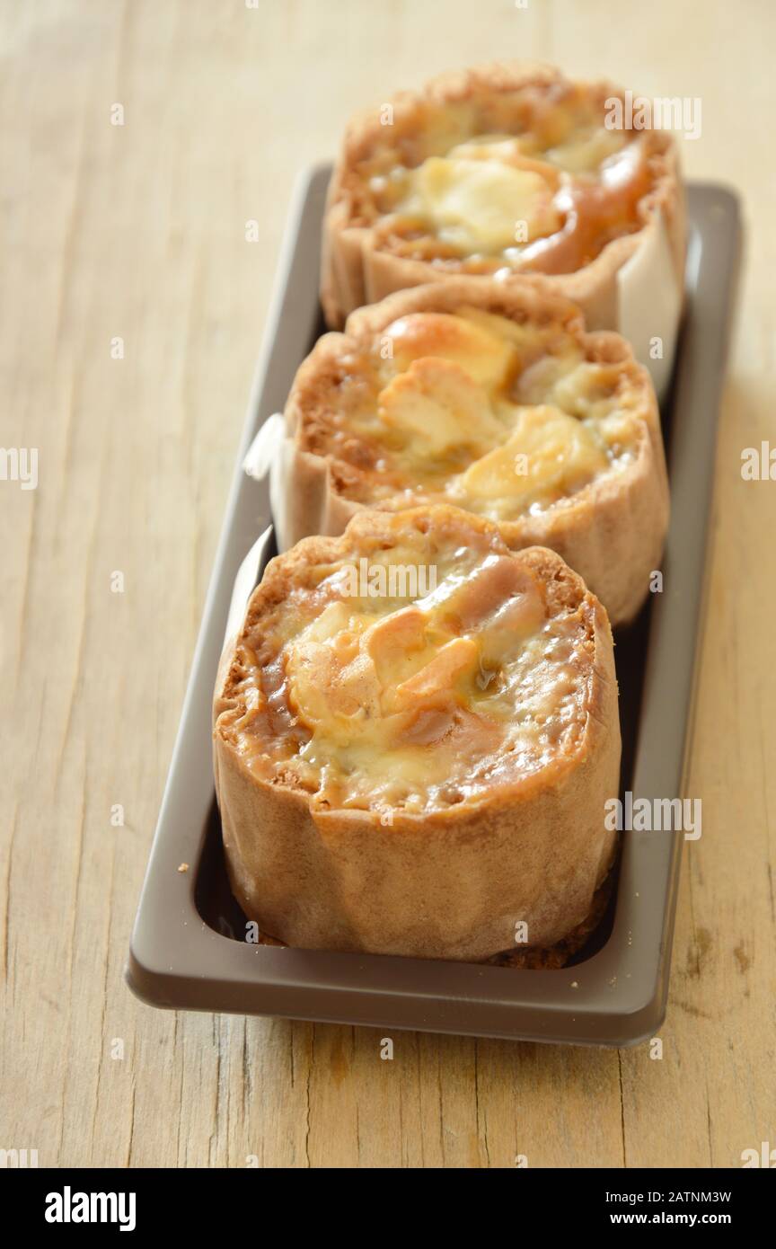 batter cupcake paper wrapped topping custard cream and chew nut on ...