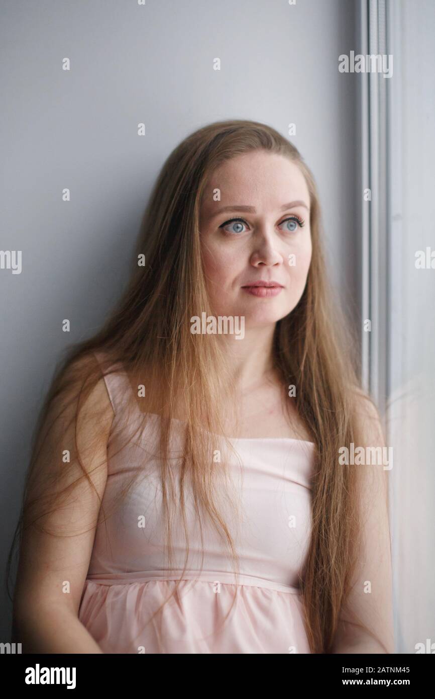 Portrait of young attractive female with beautiful long hair sitting ...