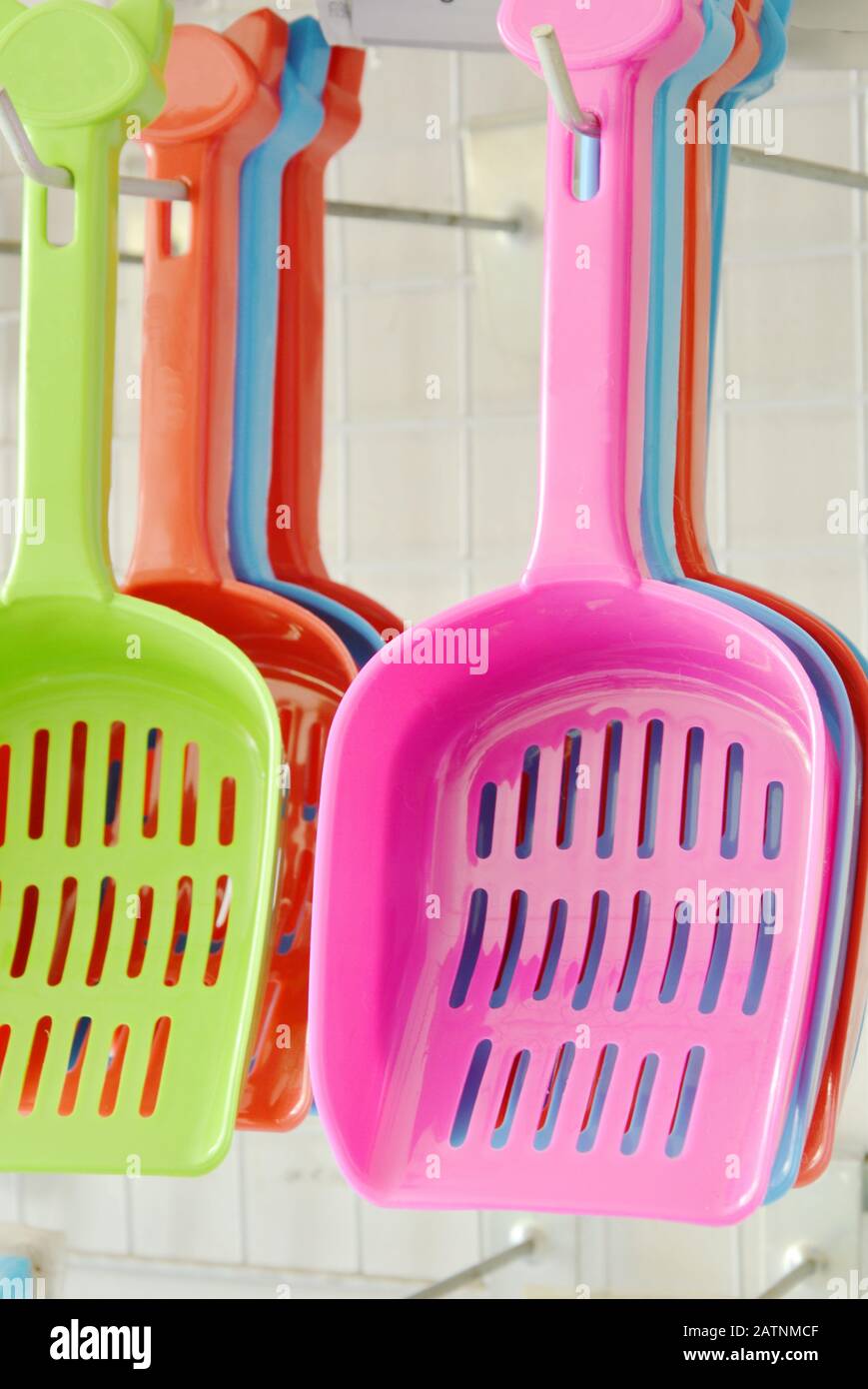 plastic cat litter shovel hanging on hook displays in pet shop Stock ...