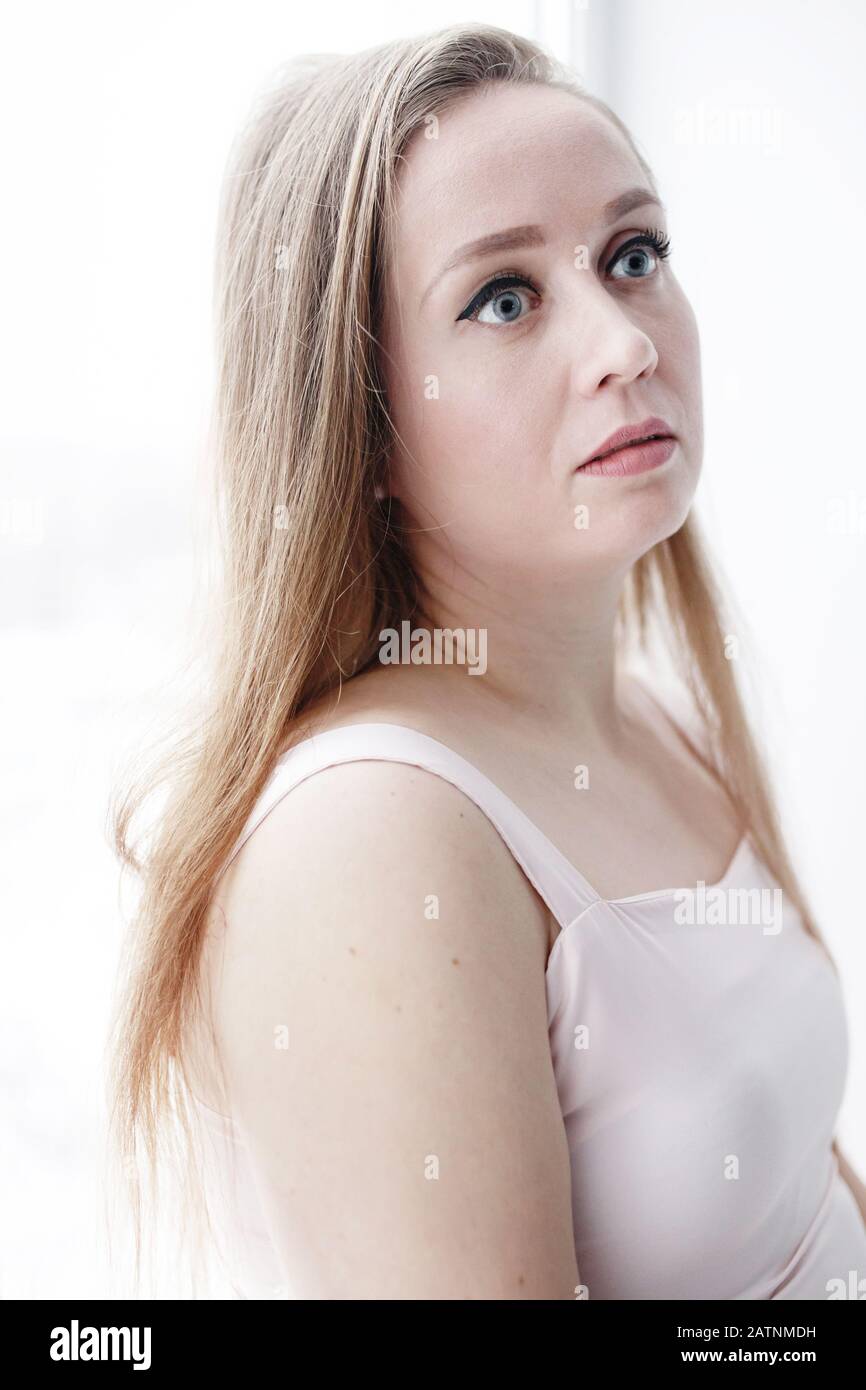 Close-up headshot portrait of young attractive woman with tranquil ...