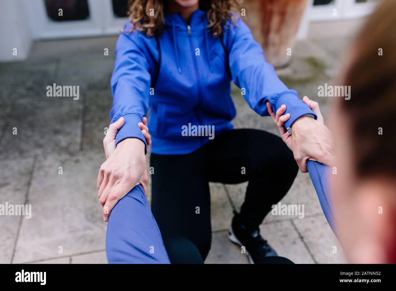 Two young women doing exercise together on a terrace Stock Photo - Alamy