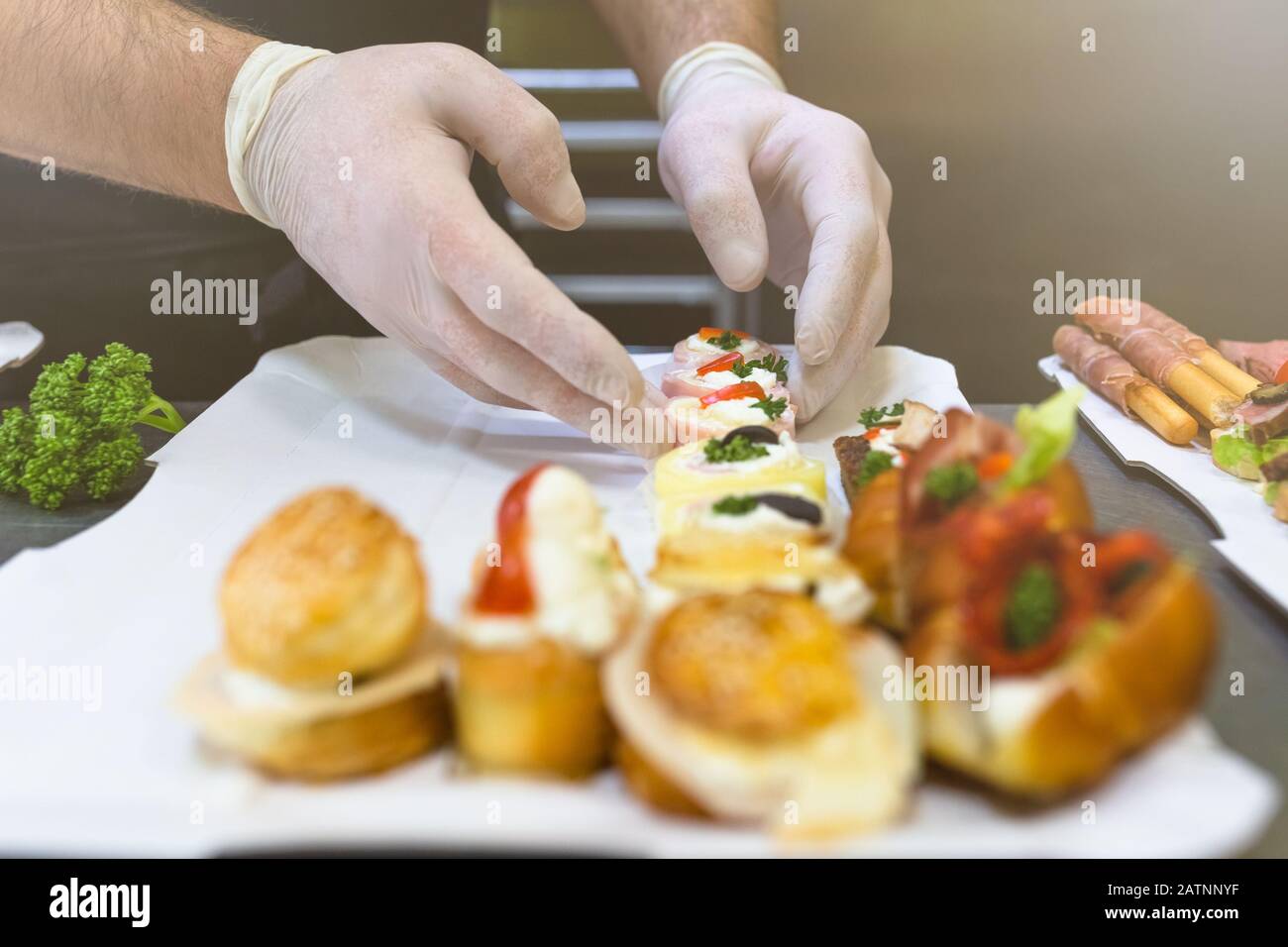 Chef preparing finger food on paper plate for delivery Stock Photo - Alamy