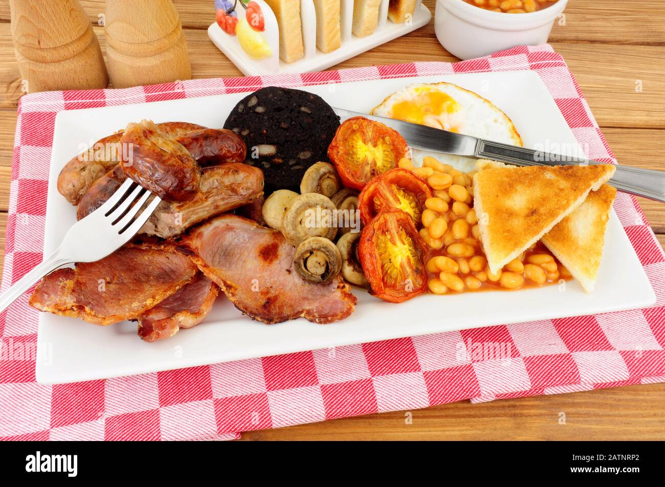 Traditional full English breakfast with sausages and bacon Stock Photo ...