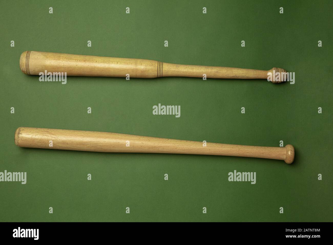 Bright wooden bat. Professional sport equipment isolated on green ...